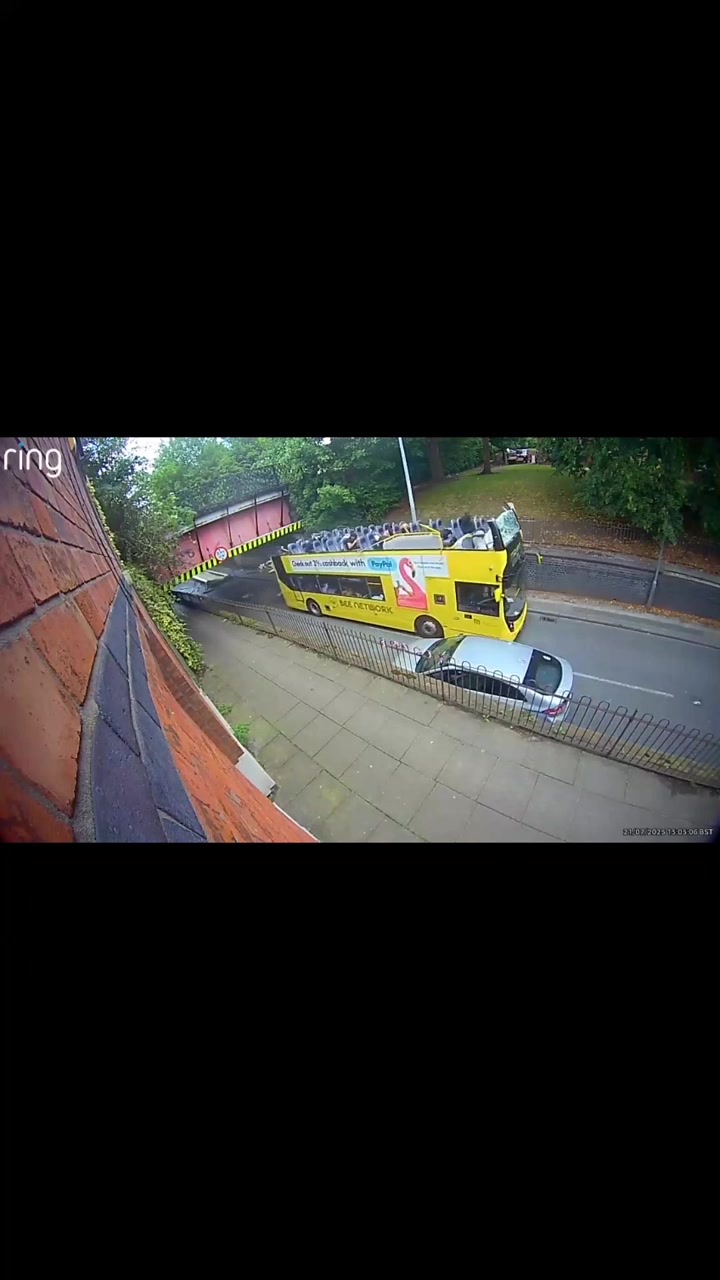 Double Decker Bus Drives Under A Low Bridge In Manchester
